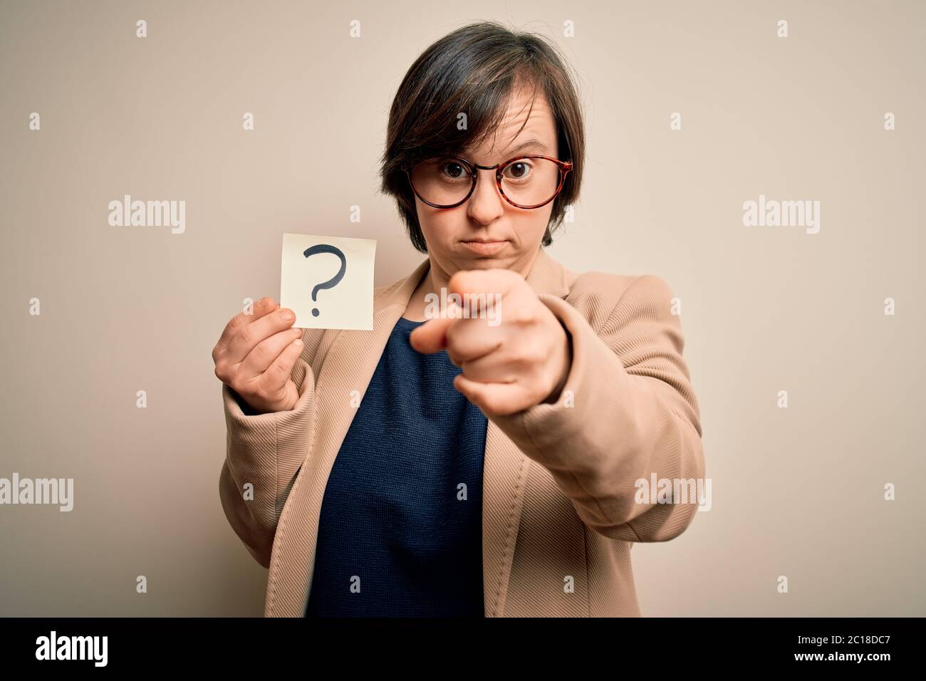 Young down syndrome business woman holding question mark paper as doubt ...