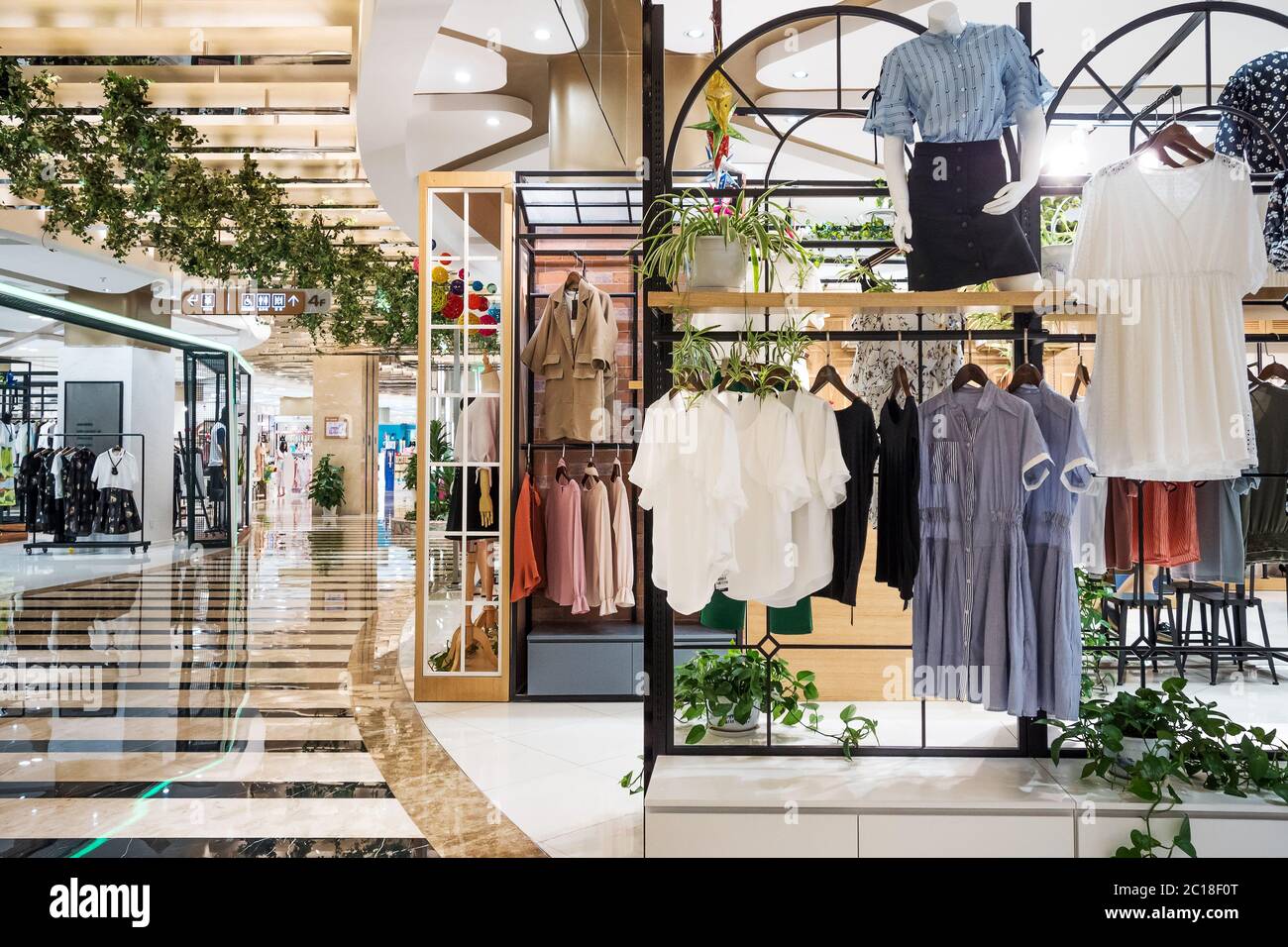 fashionable clothes in modern shopping mall Stock Photo - Alamy