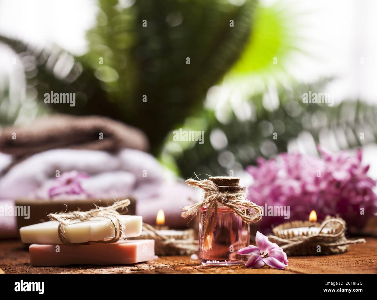 Spa background in range of pink and brown. Green leaves background ...