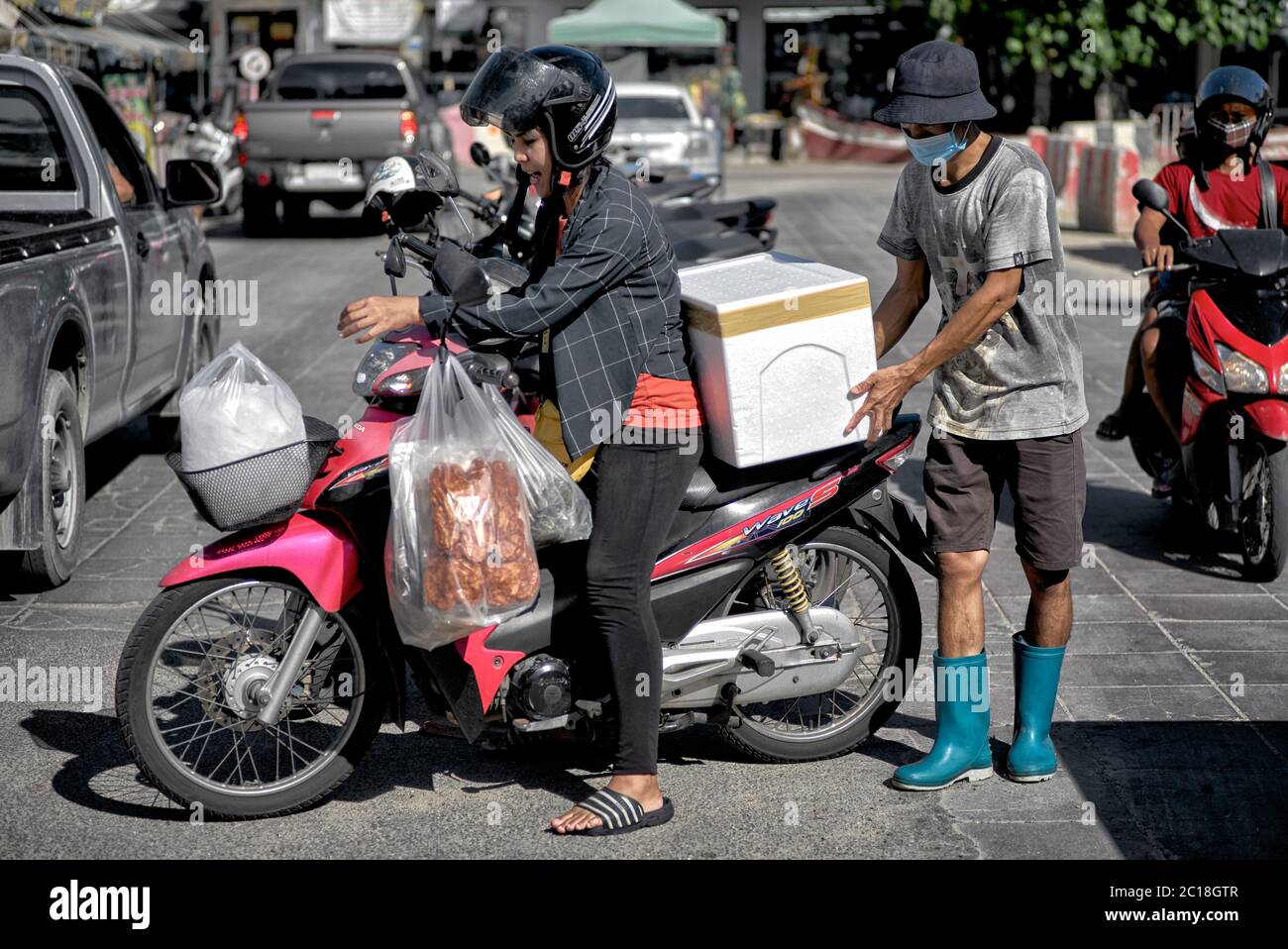 Overload motorcycle. Woman carrying her shopping load on a motorbike ...