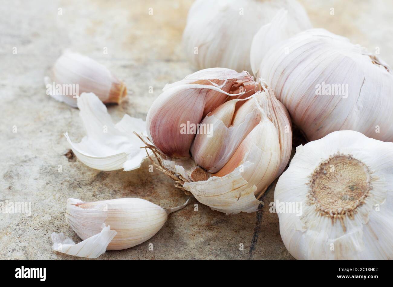 Garlic on old floor Stock Photo - Alamy