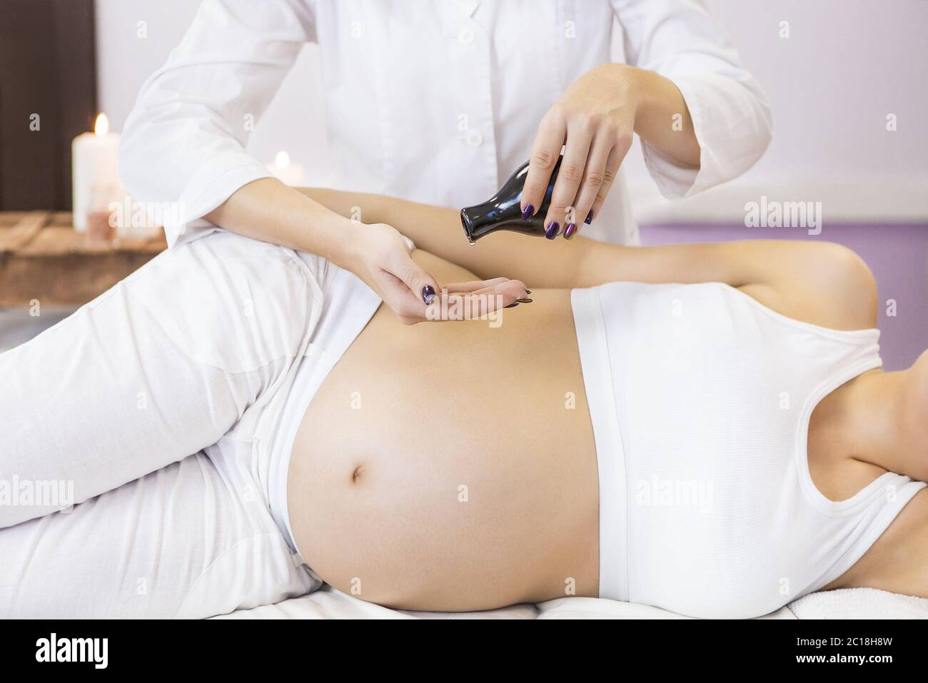 Young pregnant woman have massage treatment at spa Stock Photo - Alamy