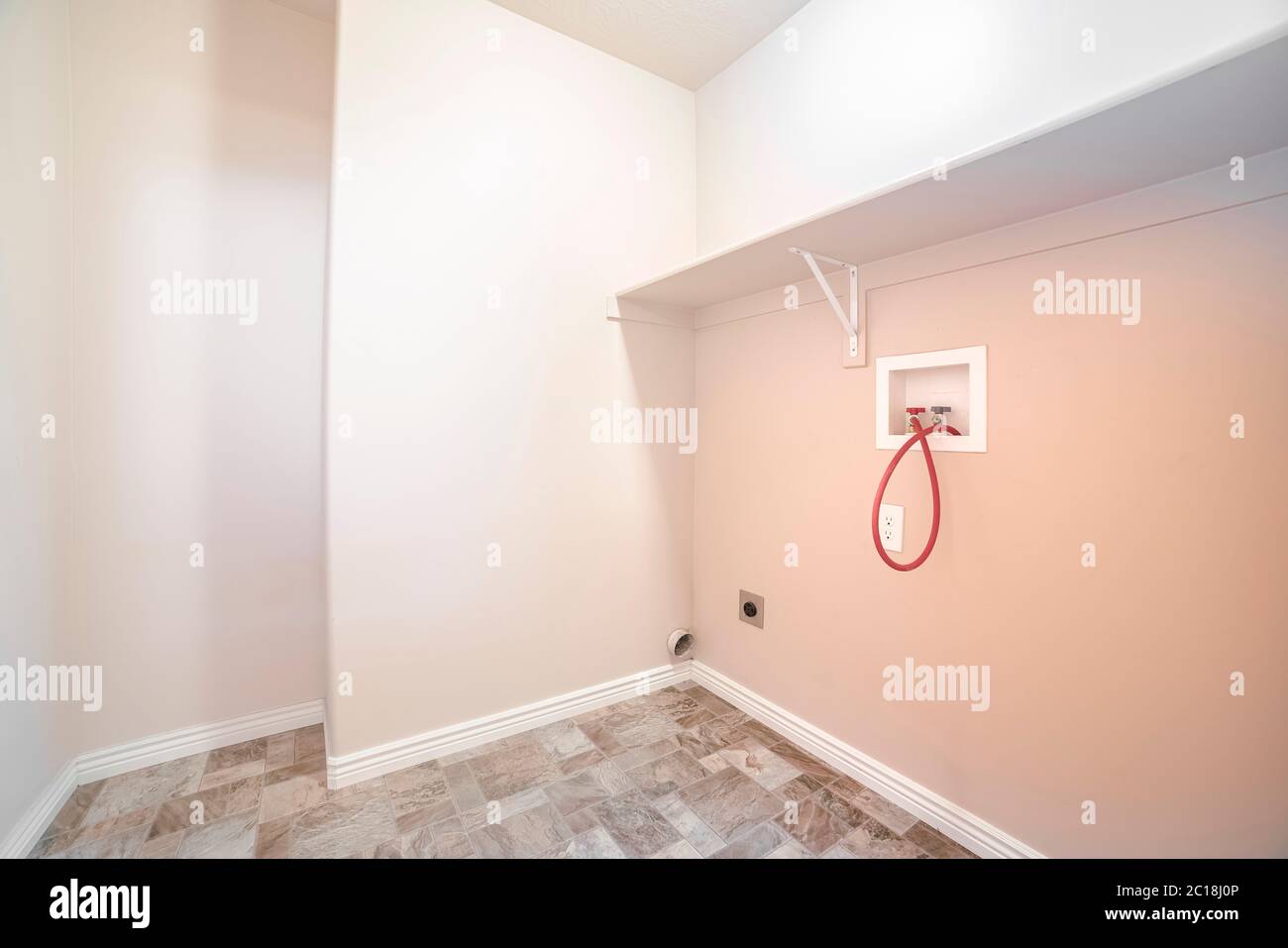 Empty laundry room with service connections interior Stock Photo - Alamy