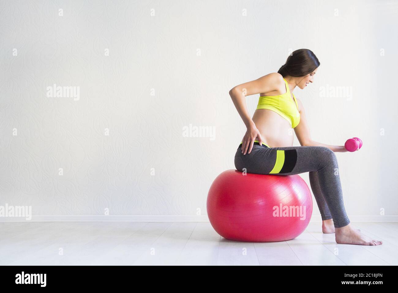 One young pregnant woman doing fitness exercises Stock Photo - Alamy