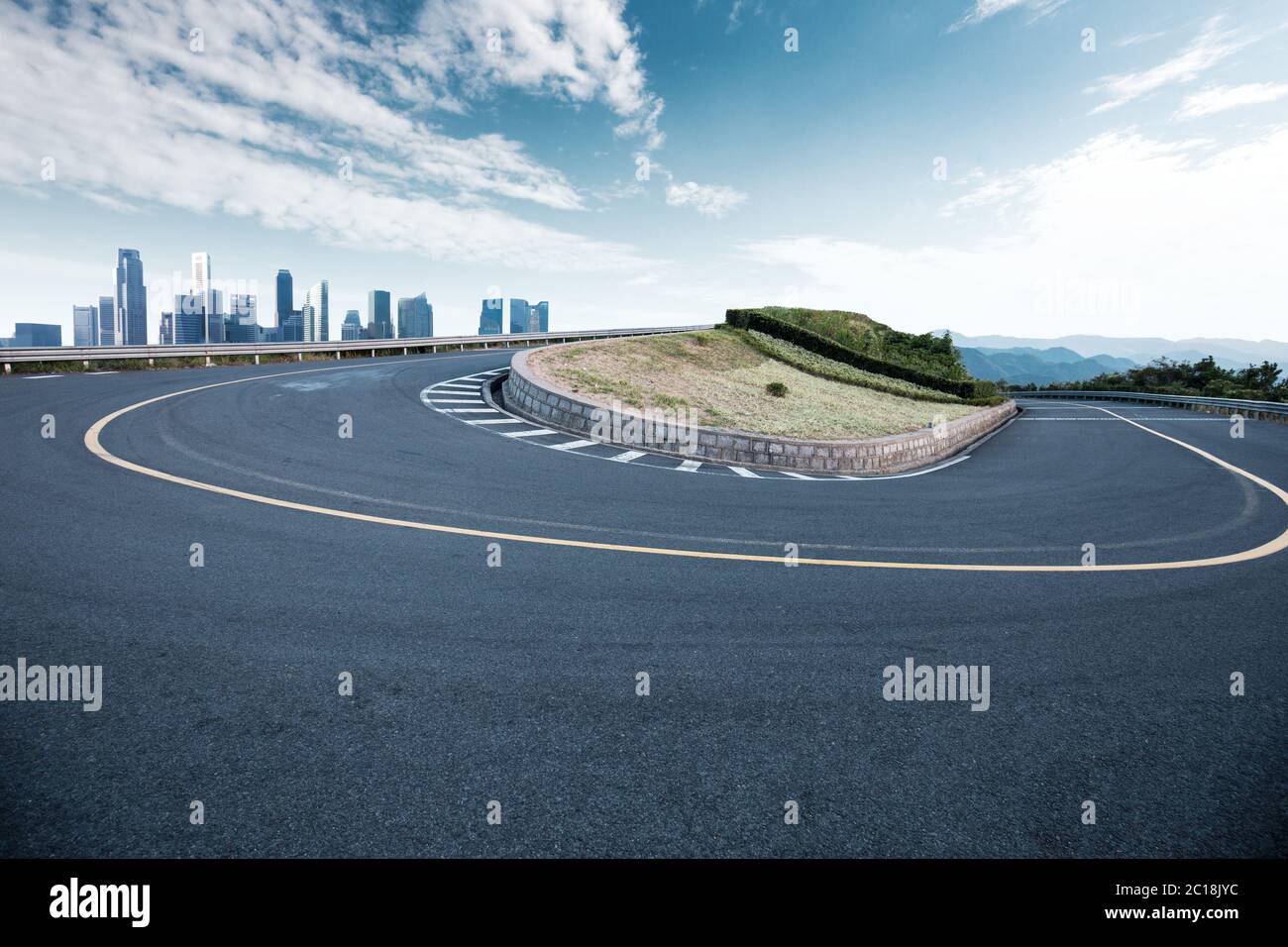 empty asphalt sharp turn with modern city Stock Photo - Alamy