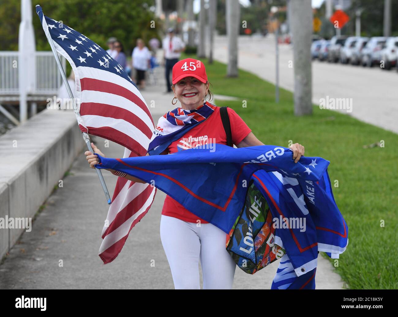 Palm Beach, FL, USA. 14th June, 2020. Trump Supporter wave flags as ...