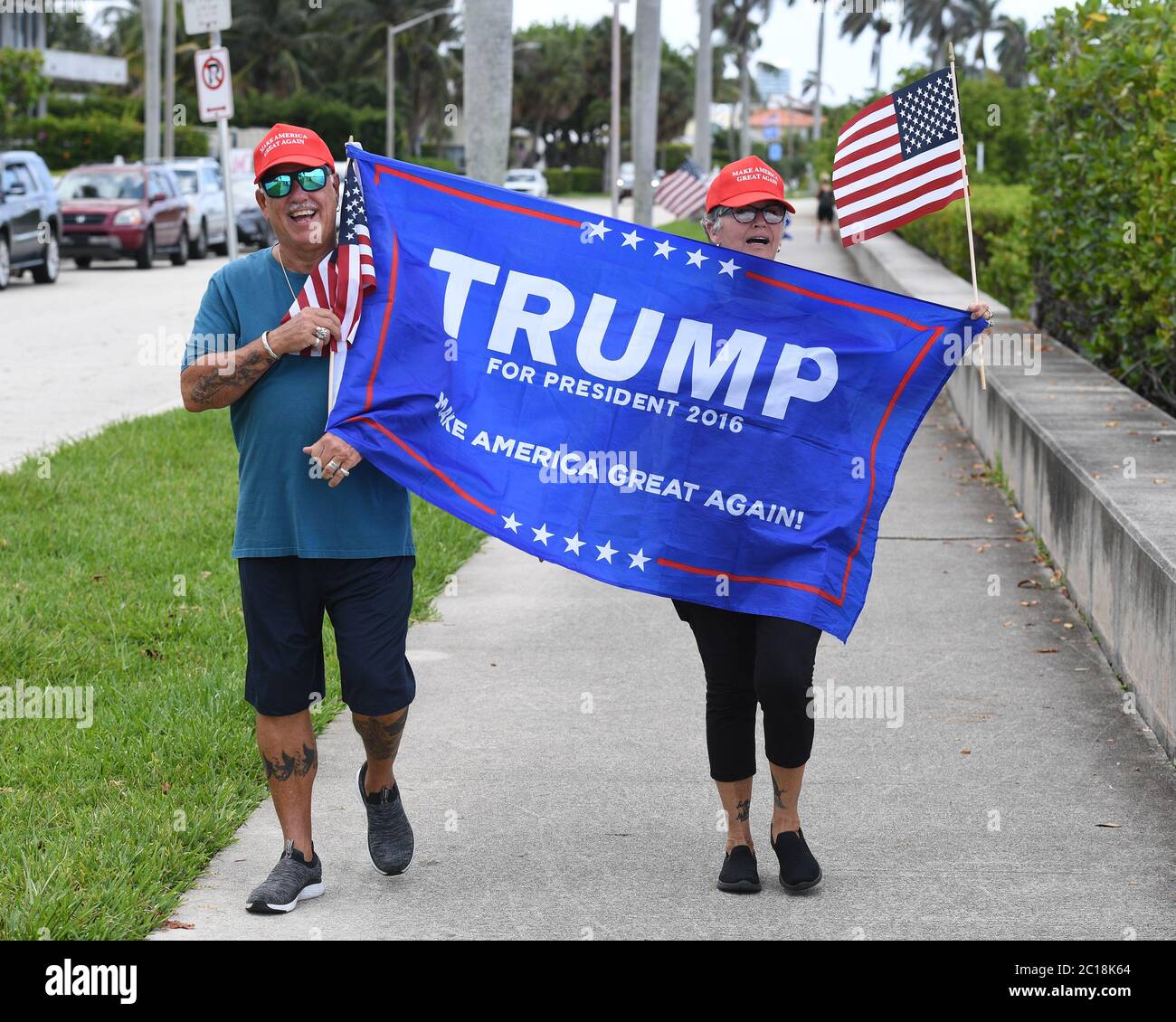 Palm Beach, FL, USA. 14th June, 2020. Trump Supporter wave flags as ...