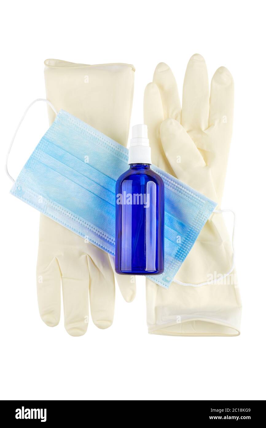 Antiseptic spray, blue medical face mask and sterile rubber gloves ...