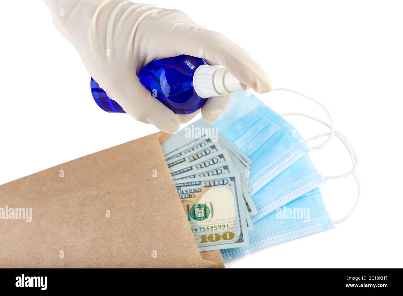 Antiseptic spray in hand, blue medical face masks and stack of 100 USD ...