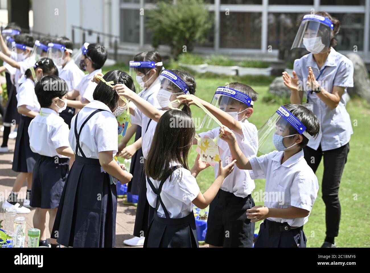 First-grade elementary school students each receive a gift from senior ...
