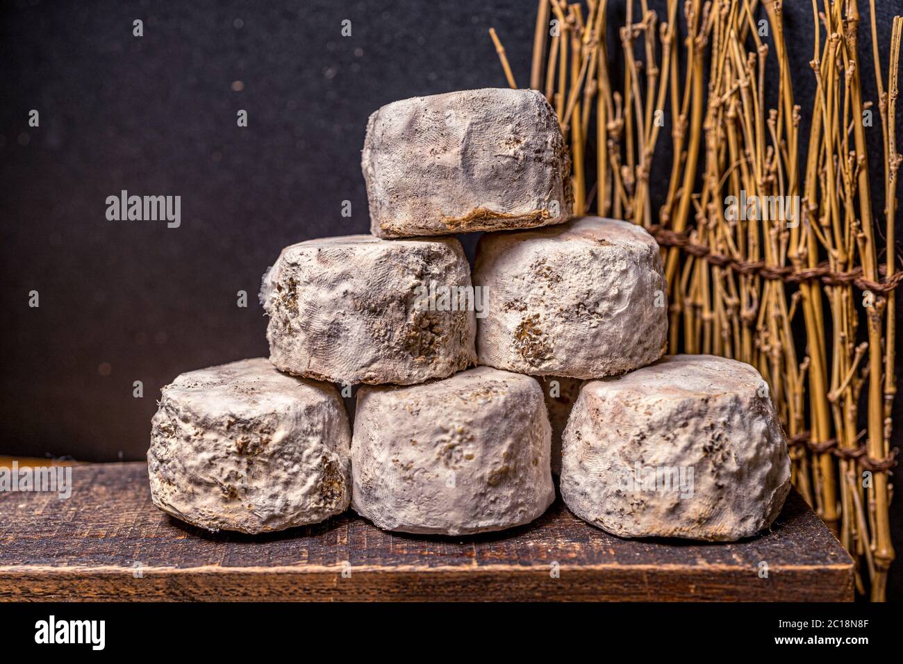 French cheese Crottin de Chavignol in the dark background. High quality ...