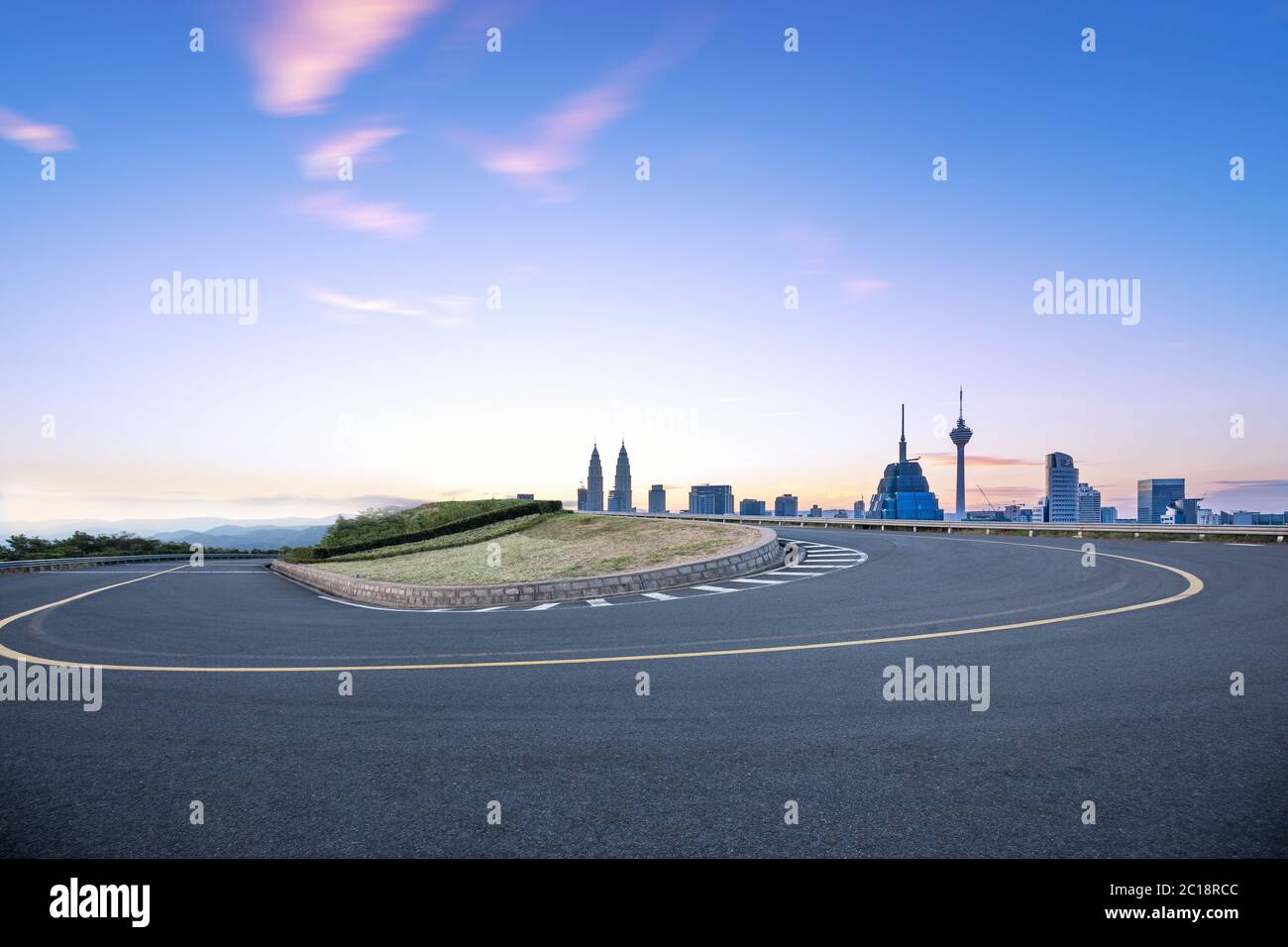 empty sharp turn road with modern city Stock Photo - Alamy