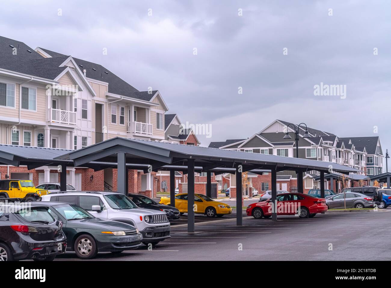 Undercover parking for cars at apartment complex Stock Photo - Alamy