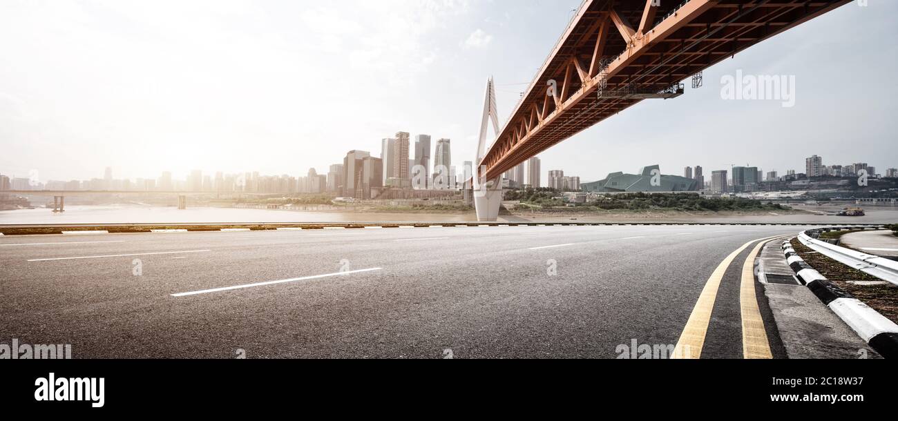 empty asphalt road with modern bridge and buildings Stock Photo - Alamy