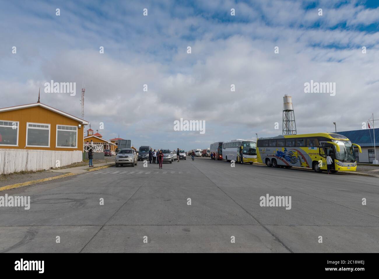 People and vehicles are waiting to board a ferry to cross the Strait of ...