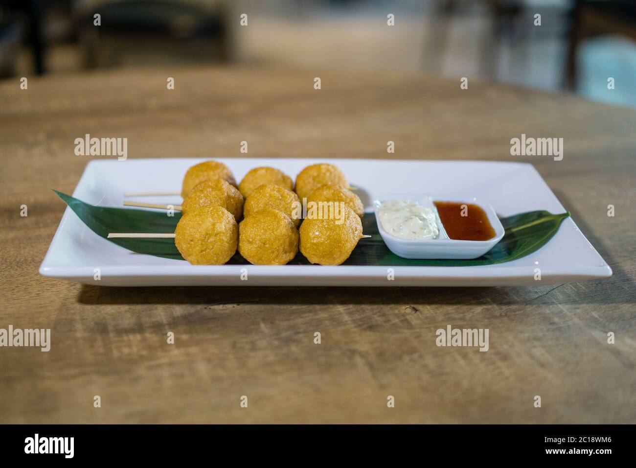 Fried fish ball served with chilli sauce and mayonnaise Stock Photo - Alamy