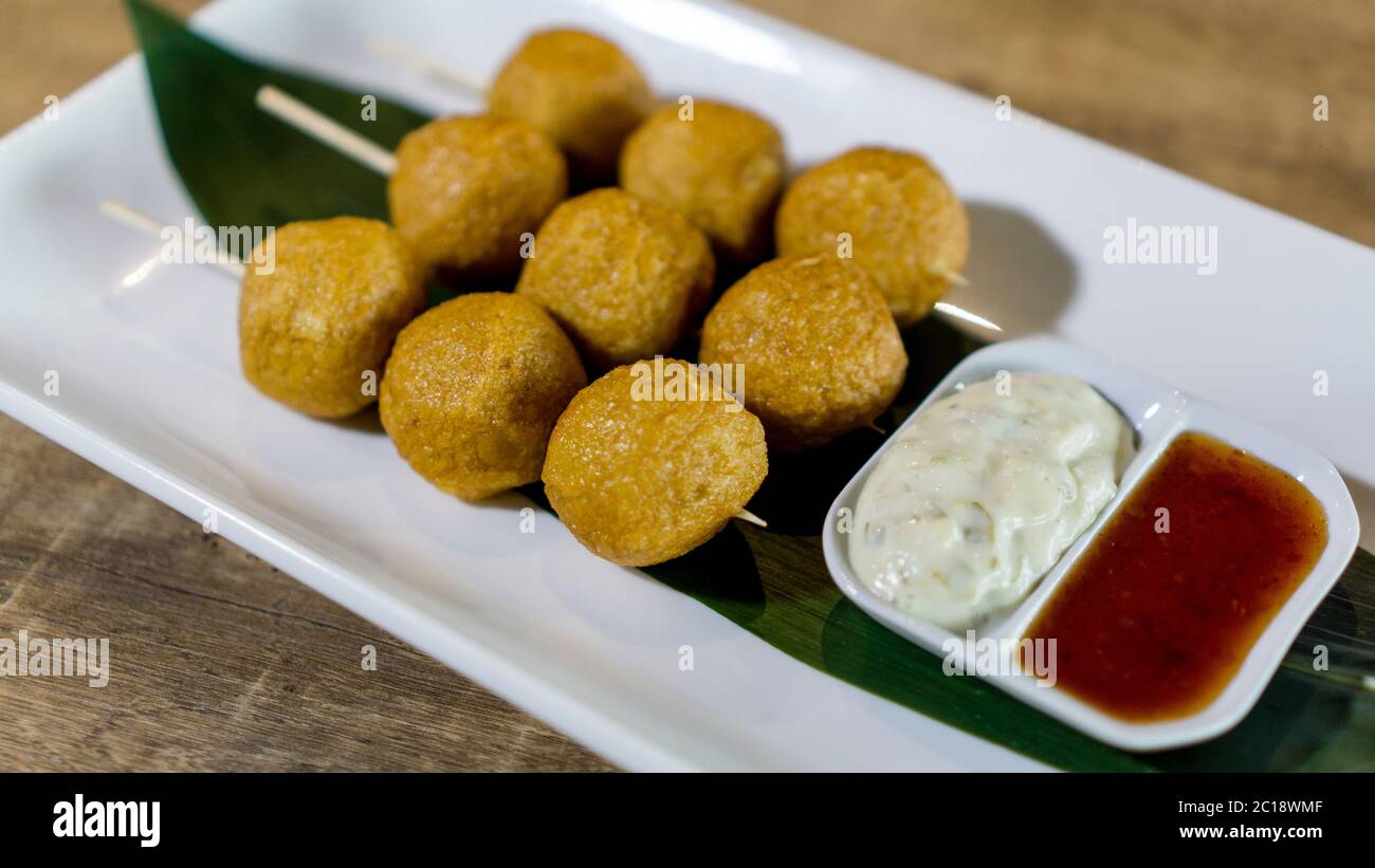 Fried fish ball served with chilli sauce and mayonnaise Stock Photo - Alamy