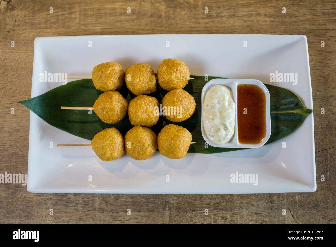 Fried fish ball served with chilli sauce and mayonnaise Stock Photo - Alamy