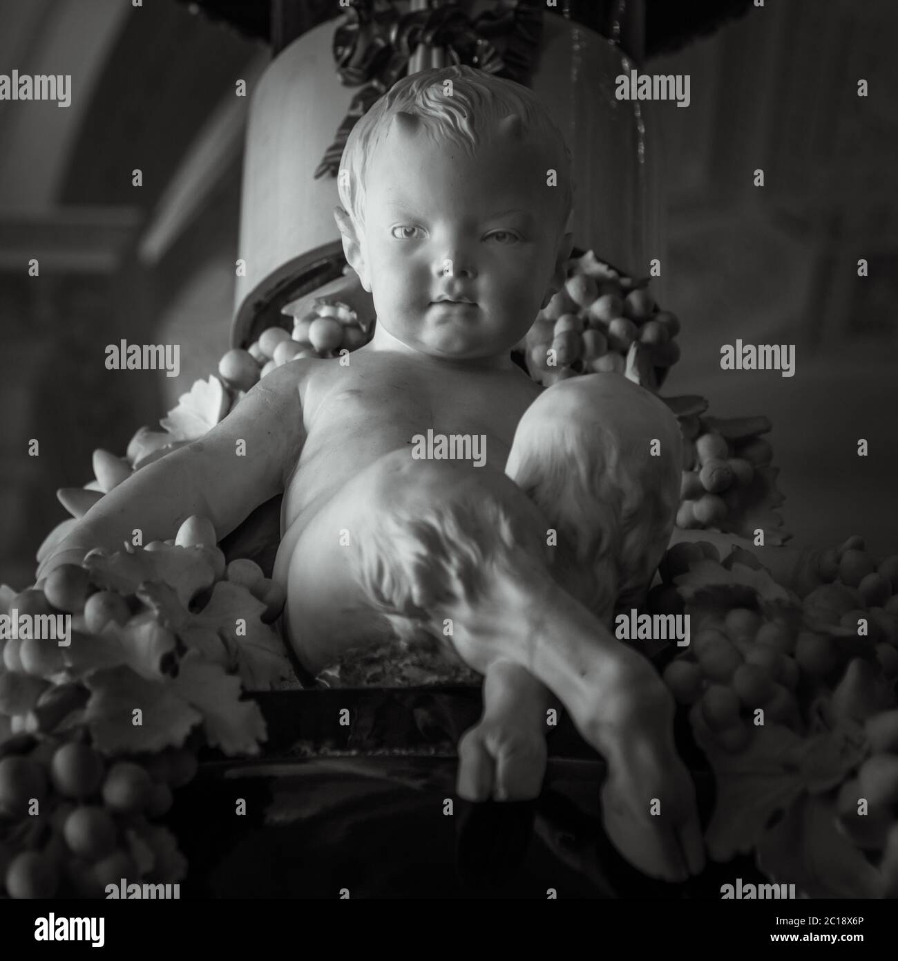 Satyr child statue with animal legs Stock Photo - Alamy
