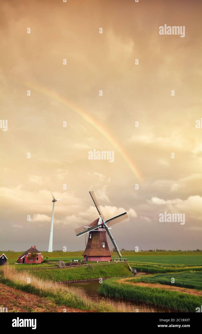 rainbow over Dutch windmill at sunset Stock Photo - Alamy