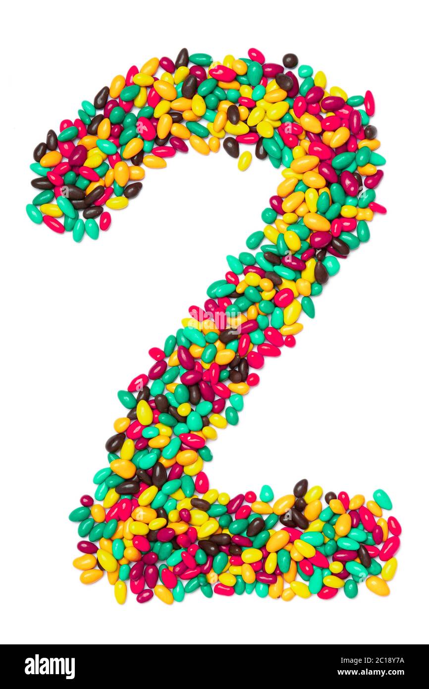 Arabic numeral "2" from multicolored round chocolates on a white ...