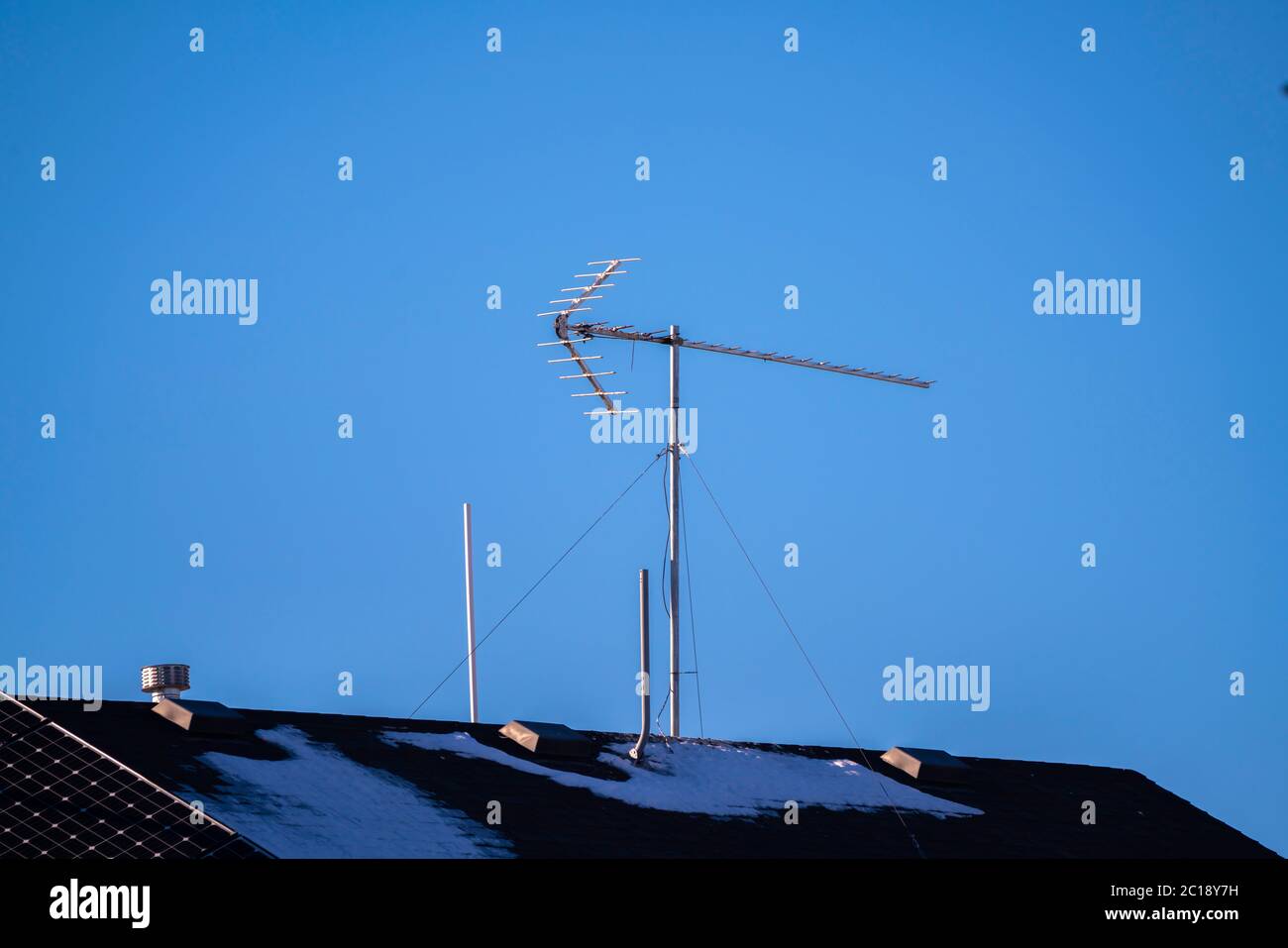 Communications antenna mounted on a rooftop day light Stock Photo - Alamy