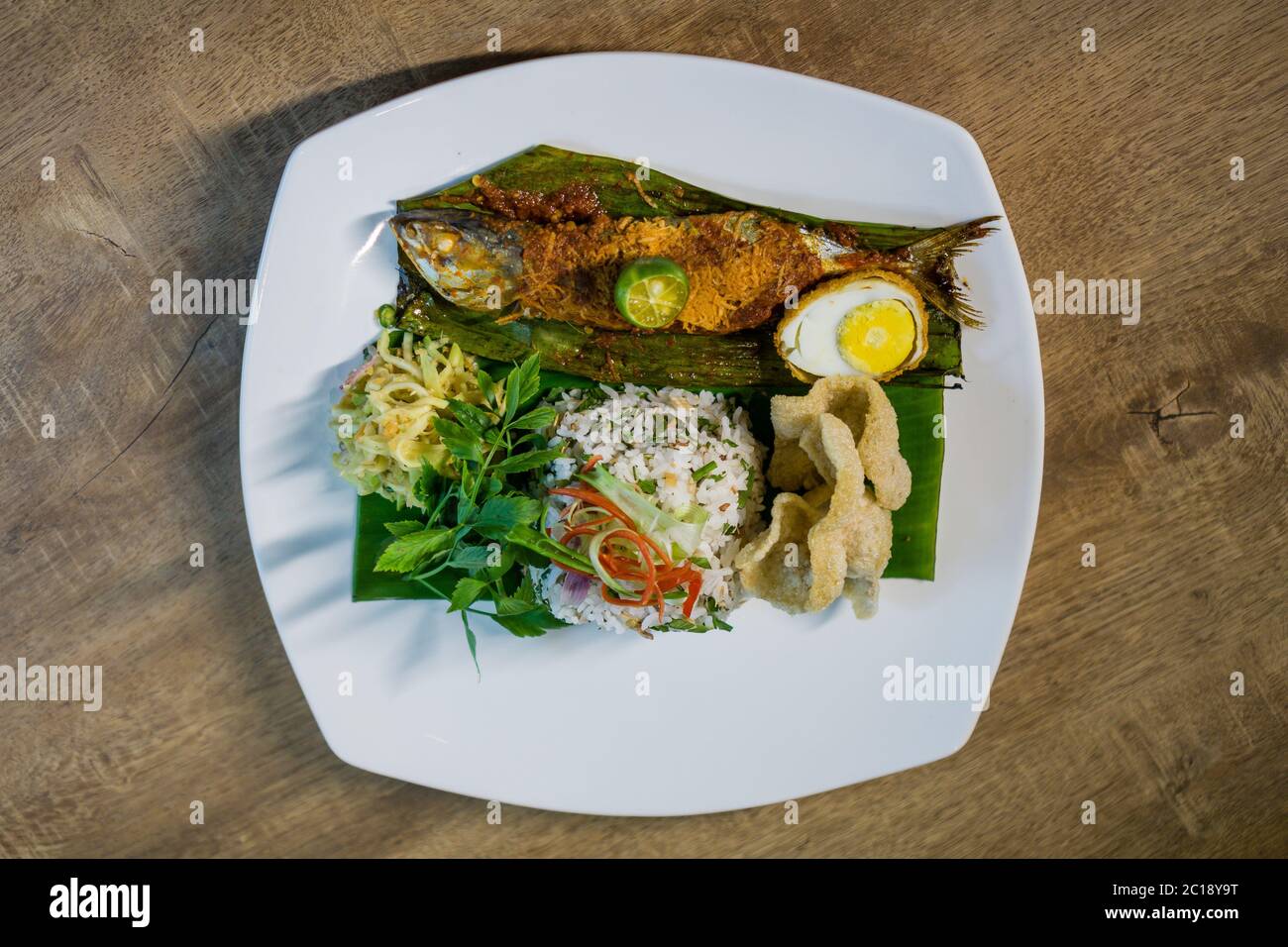 Nasi kerabu or nasi ulam, popular Malay rice dish. Served with grilled ...