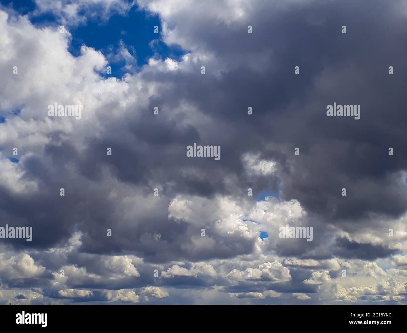 Heavy gray rain clouds in the blue sky. Atmosphere, air, cloudy, soon ...