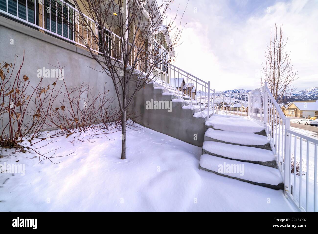 Snow covered concrete exterior entrance steps day light Stock Photo - Alamy