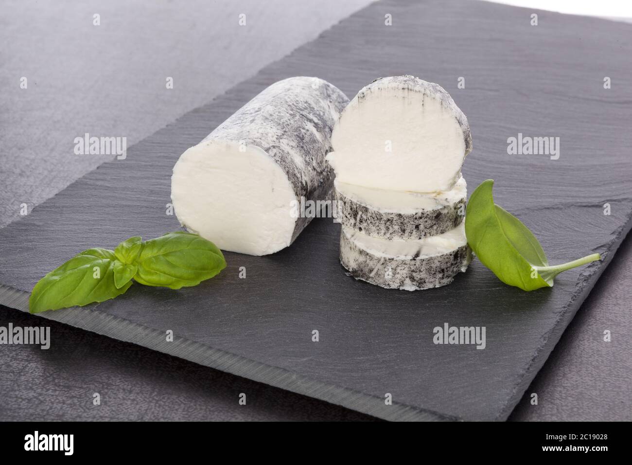 Goat cheese with basil Stock Photo - Alamy