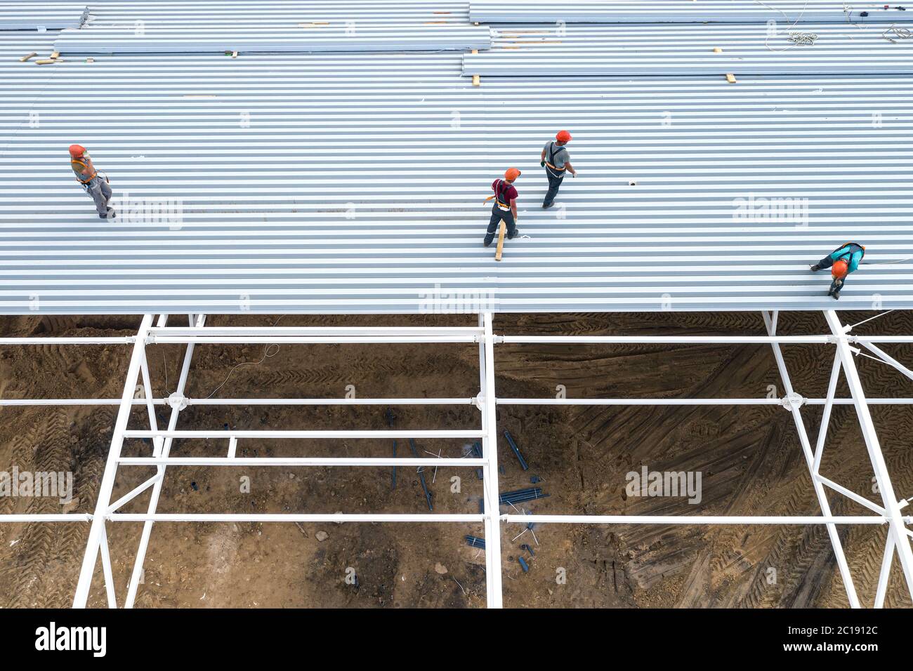 Workers install the roof of a modern frame building. Top view from a ...