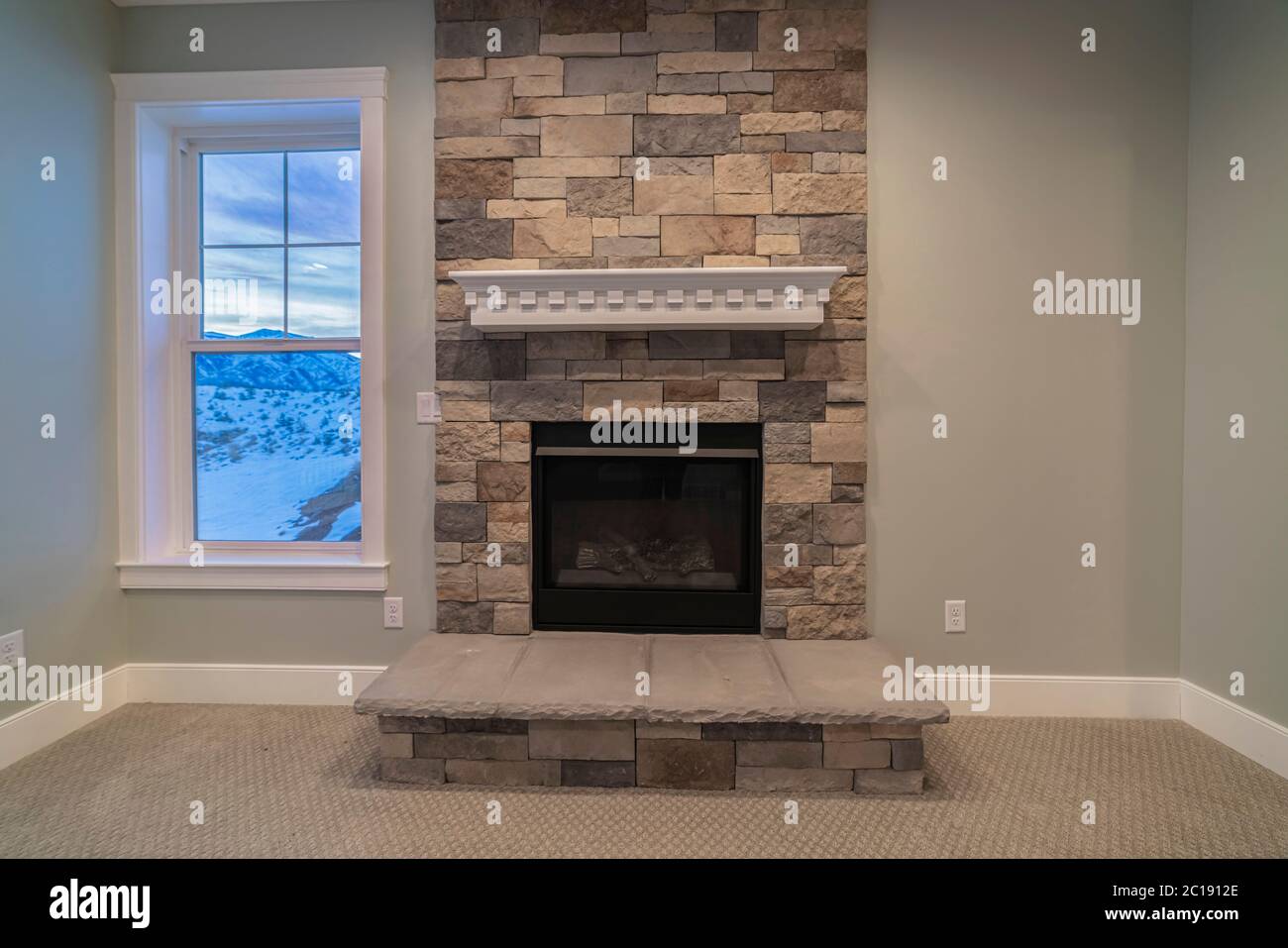 Fire insert in a feature stone brick wall Stock Photo - Alamy