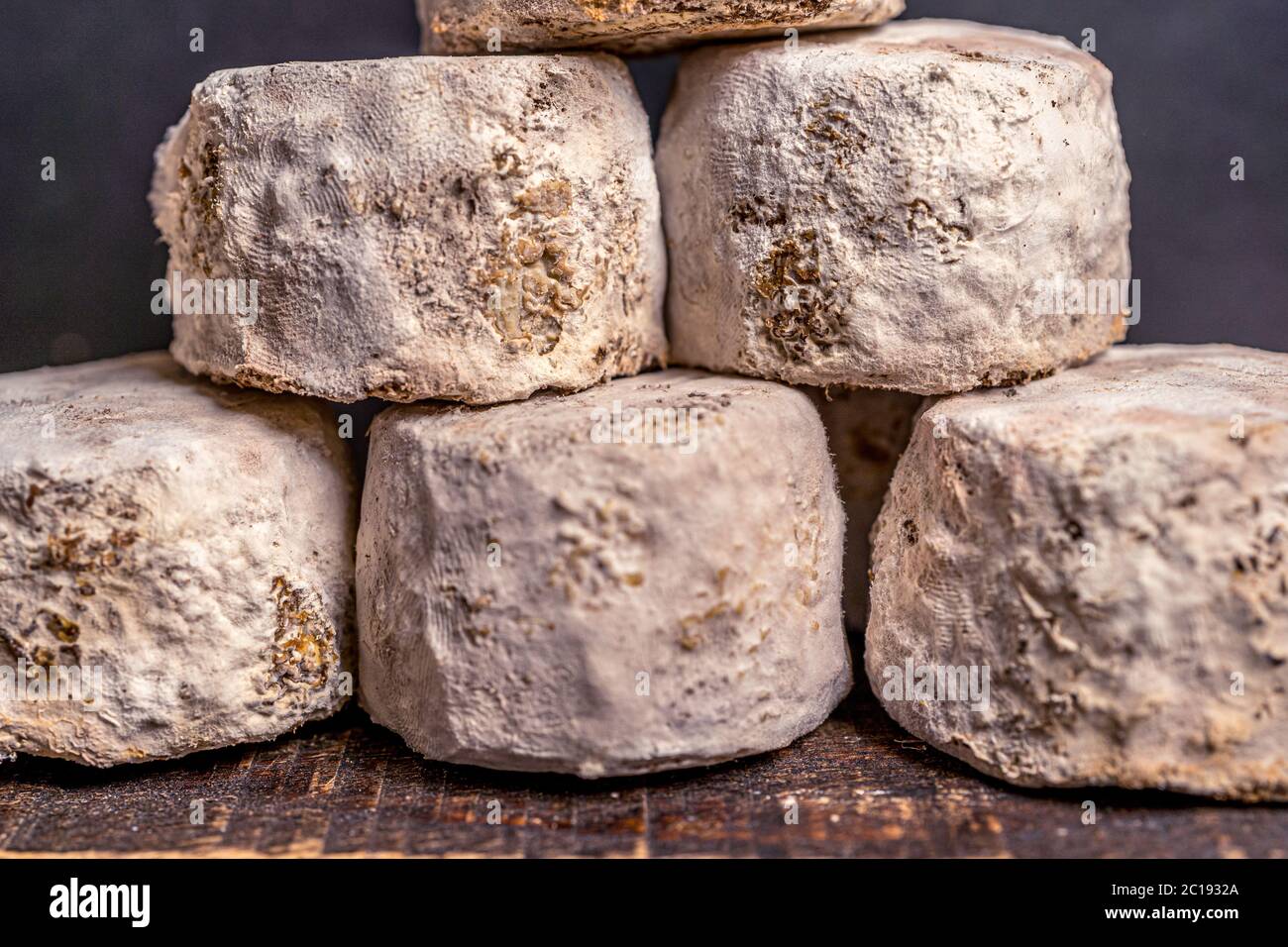 French cheese Crottin de Chavignol in the dark background. High quality ...