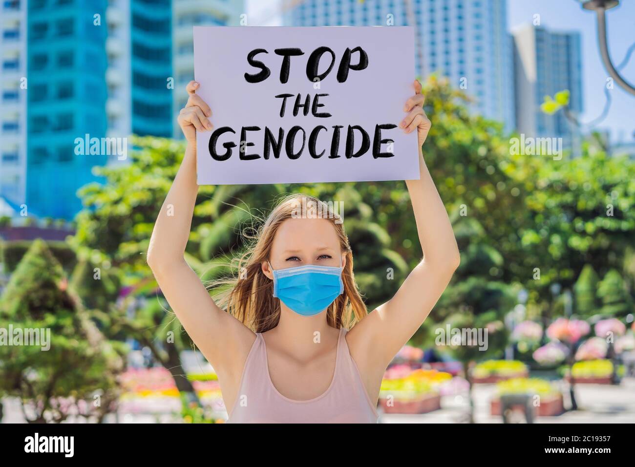 Woman holds a poster with an inscription - stop the genocide Stock ...