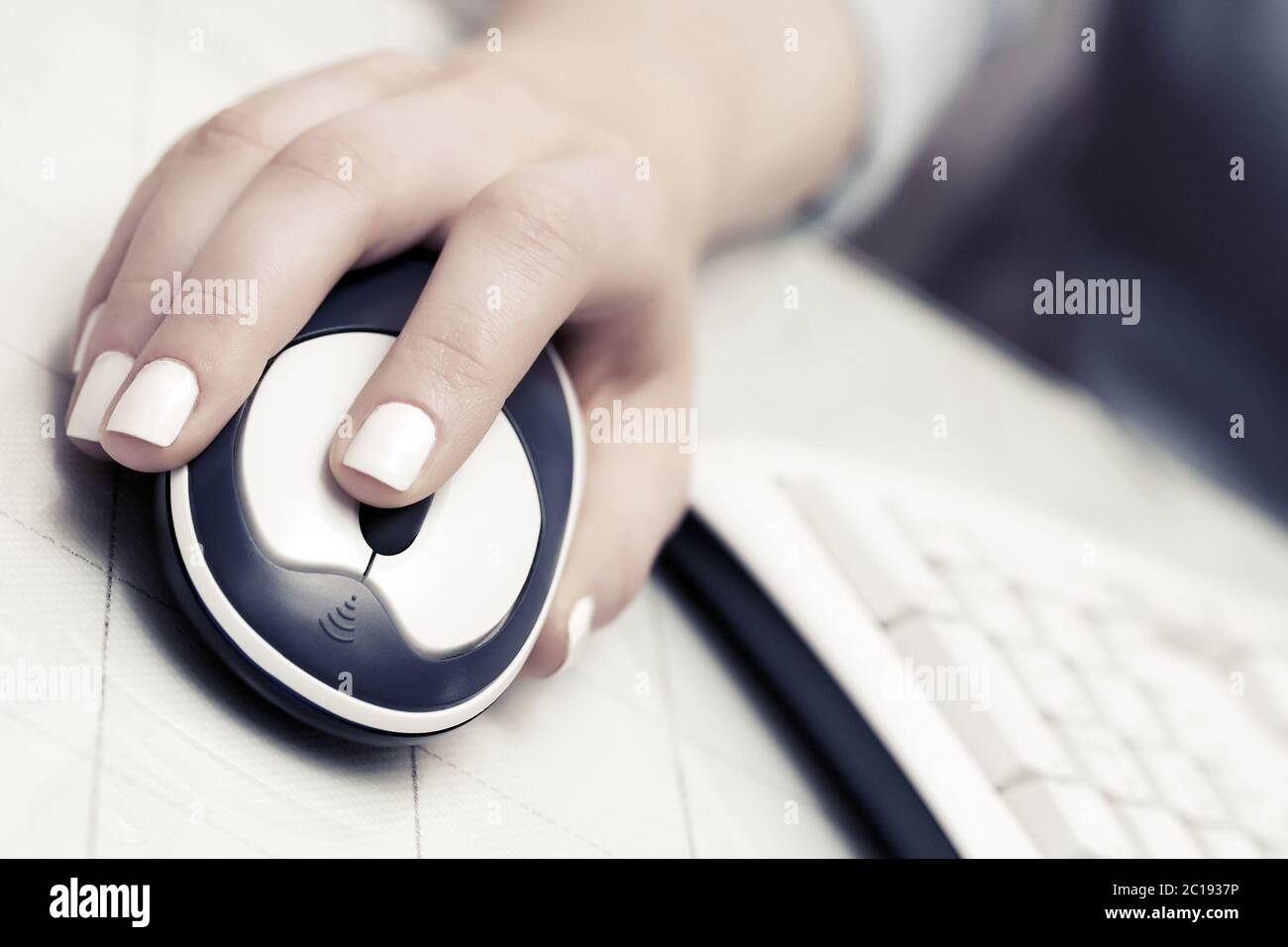 Woman using computer mouse and keyboard Stock Photo - Alamy