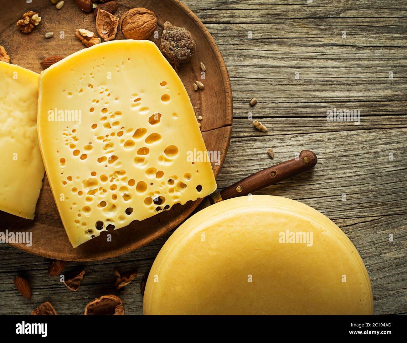 Various kind of hard cheese served on wooden table, traditional pieces ...