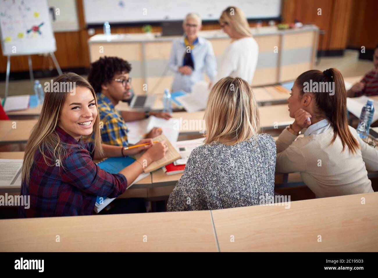 Happy female student smiling on lecture in amphitheater Stock Photo - Alamy