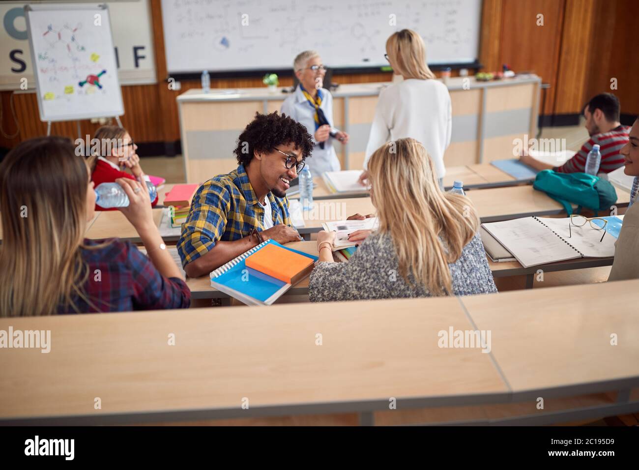Students discussing while having lecture in amphitheater Stock Photo ...
