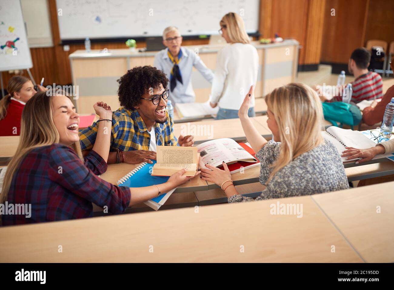 Students laughing while having lecture in amphitheater Stock Photo - Alamy