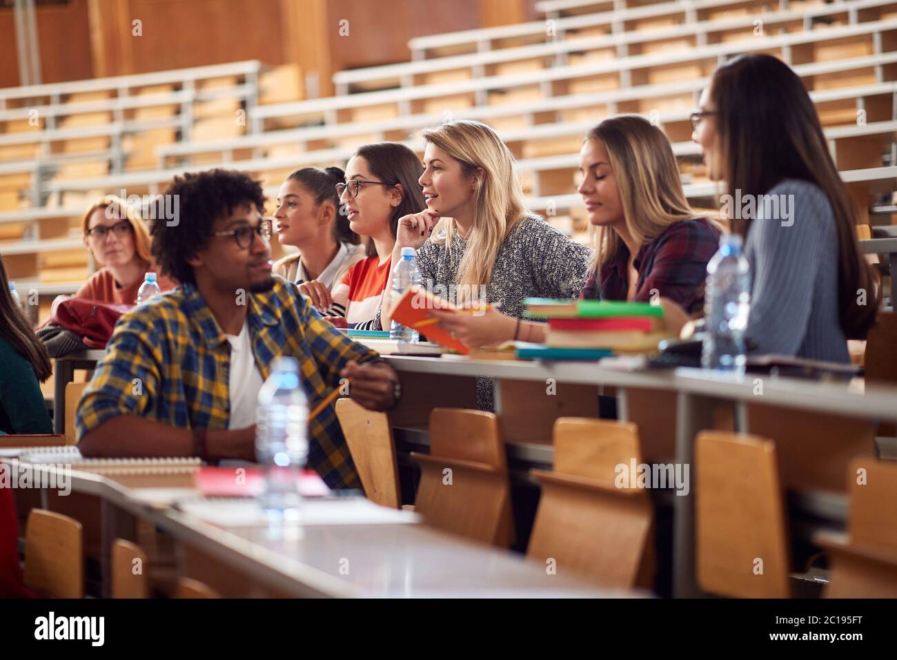 Young students focusing on lecture in amphitheater Stock Photo - Alamy