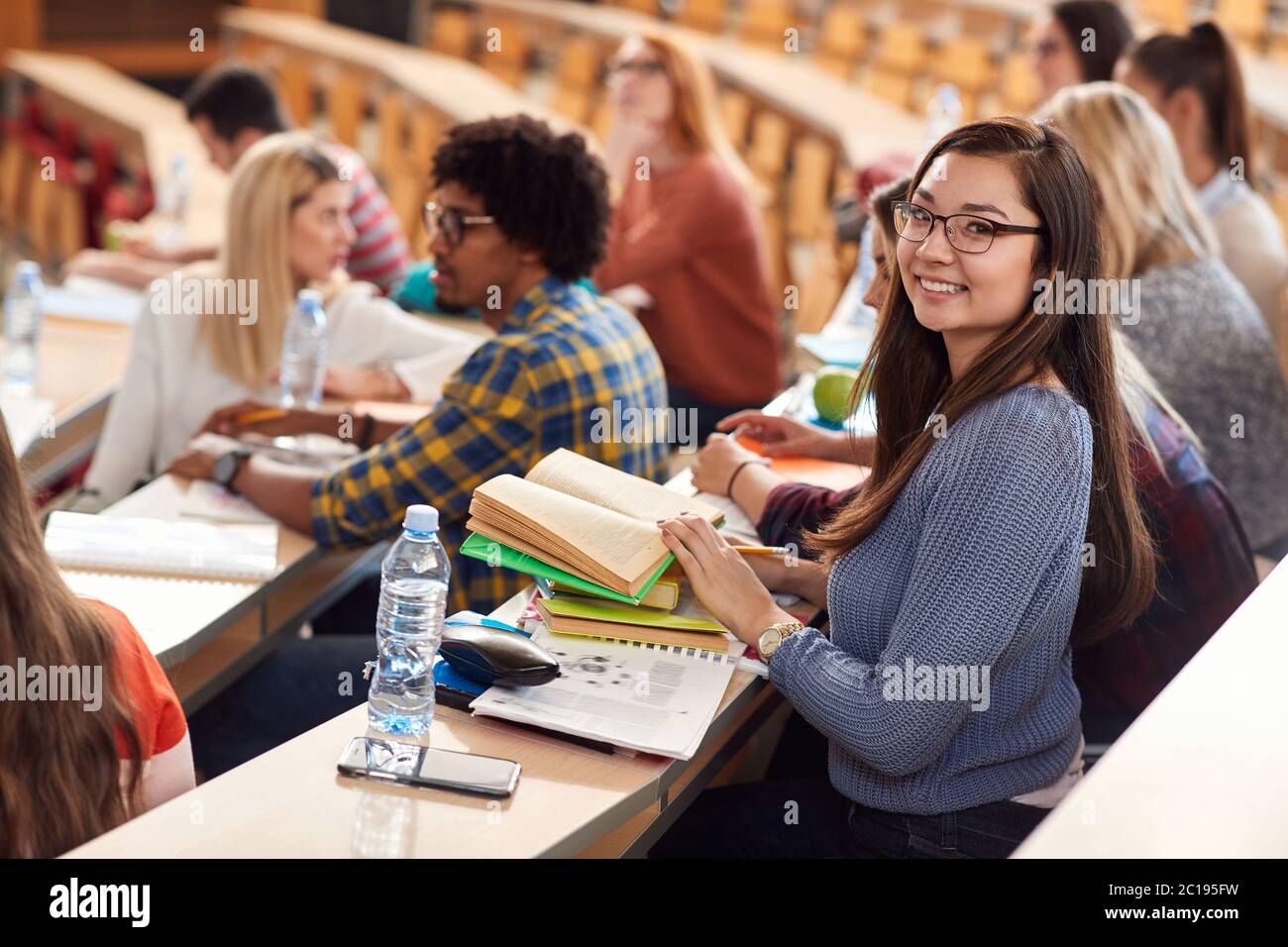 Happy students smiling on lecture in amphitheater Stock Photo - Alamy