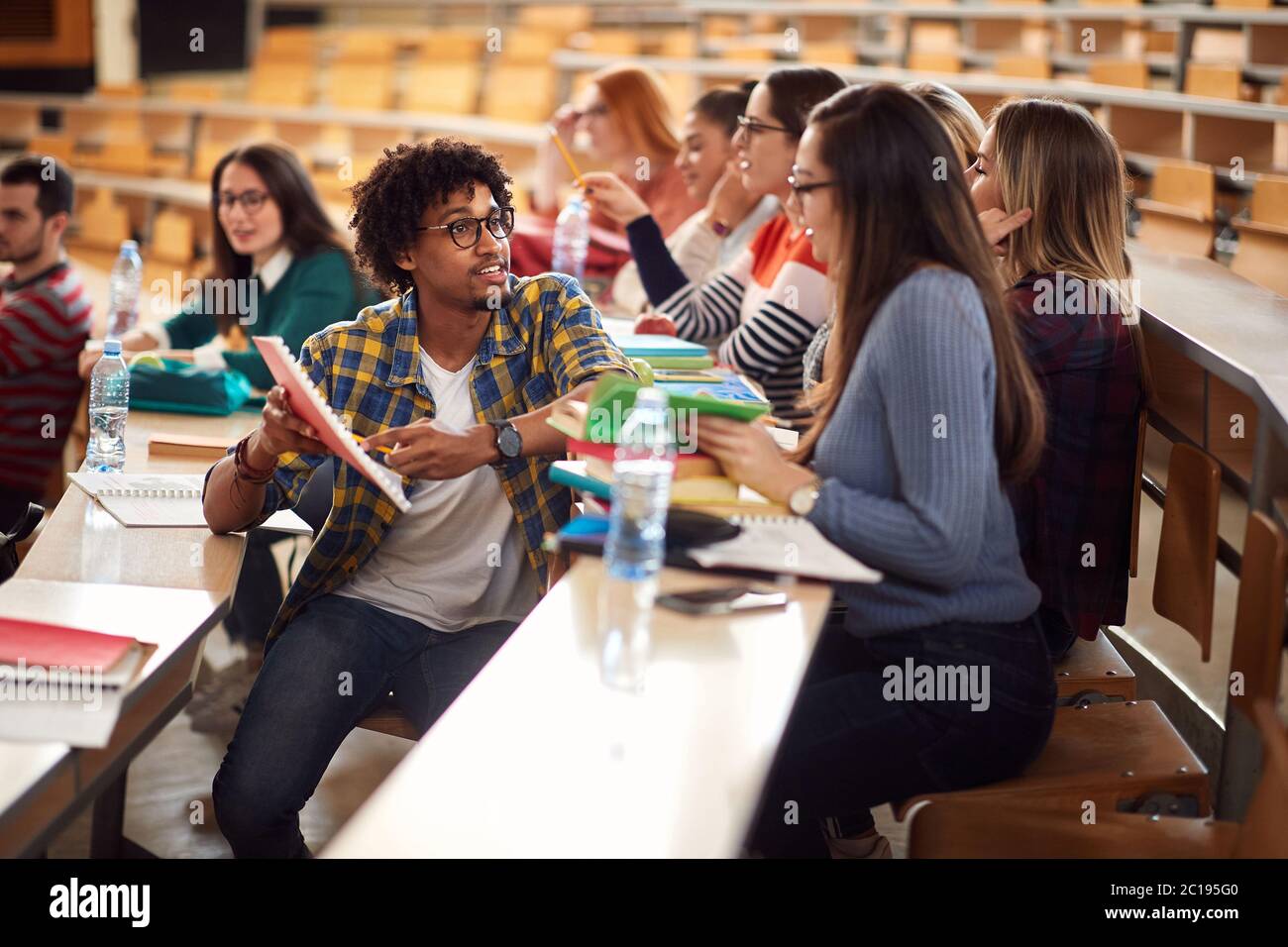 College students comparing notes in hi-res stock photography and images ...