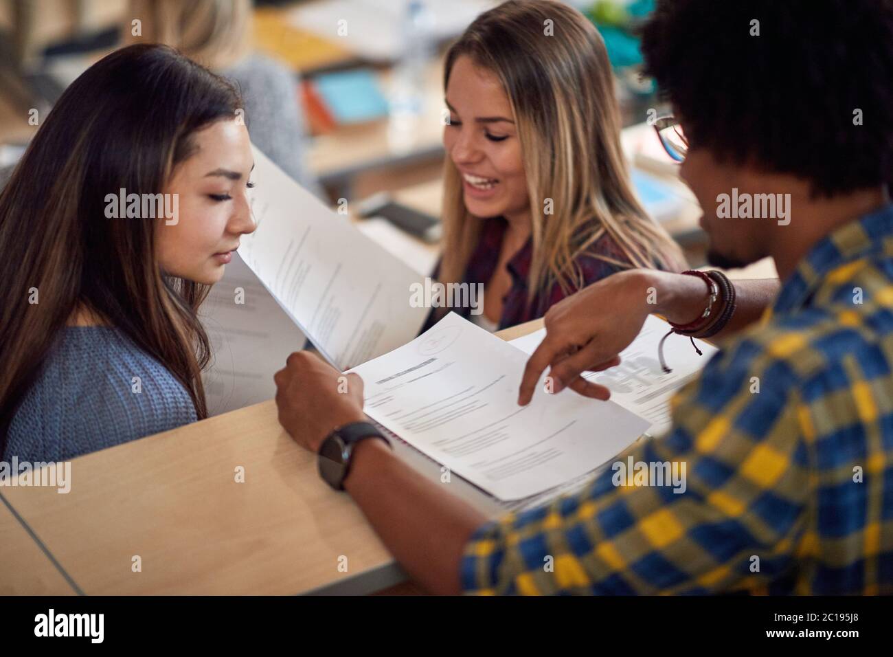 Group of happy students passed exam comparing results Stock Photo - Alamy
