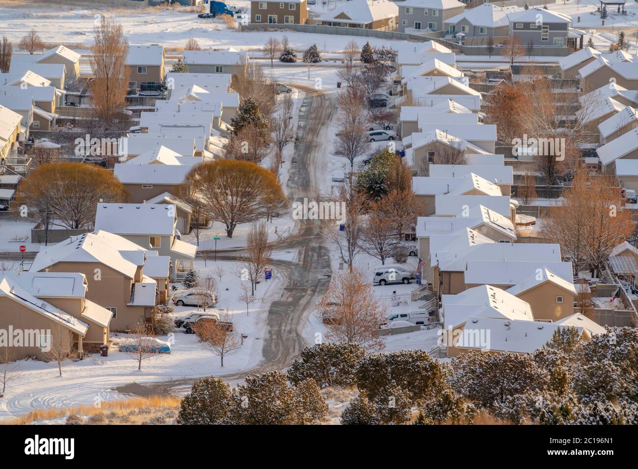 Aerial view of Utah Valley neighborhood with homes and roads on snowy ...
