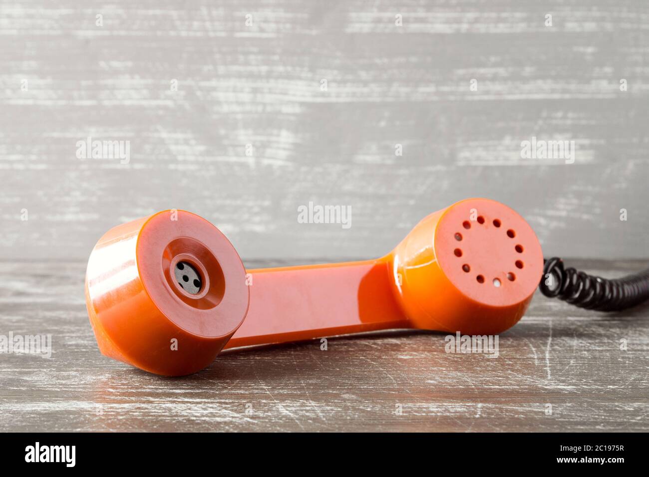 Orange telephone receiver close-up Stock Photo - Alamy