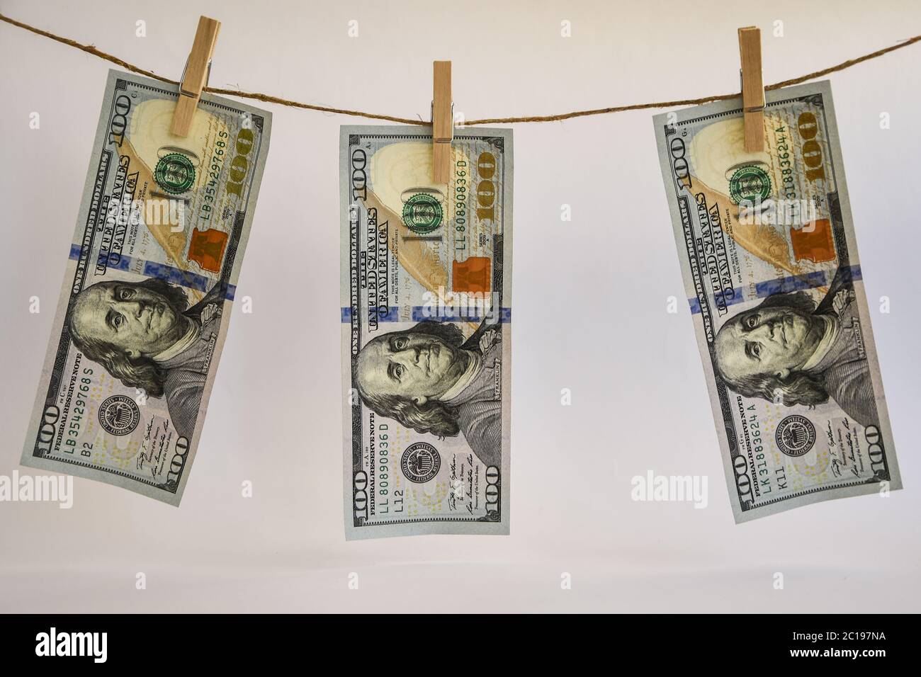 100 dollars on a rope, dollars with a clothespin on a rope isolated on ...