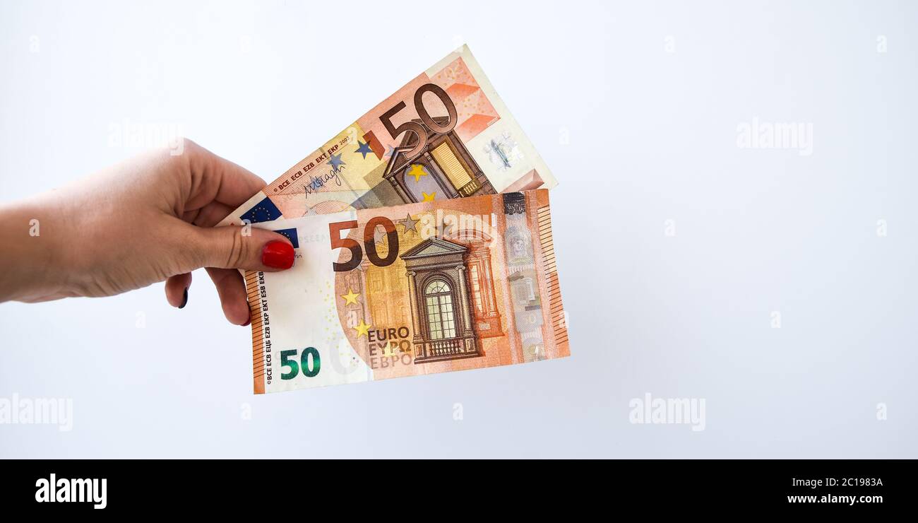 Woman's hand with 50 euros money on a white background, copy space for ...