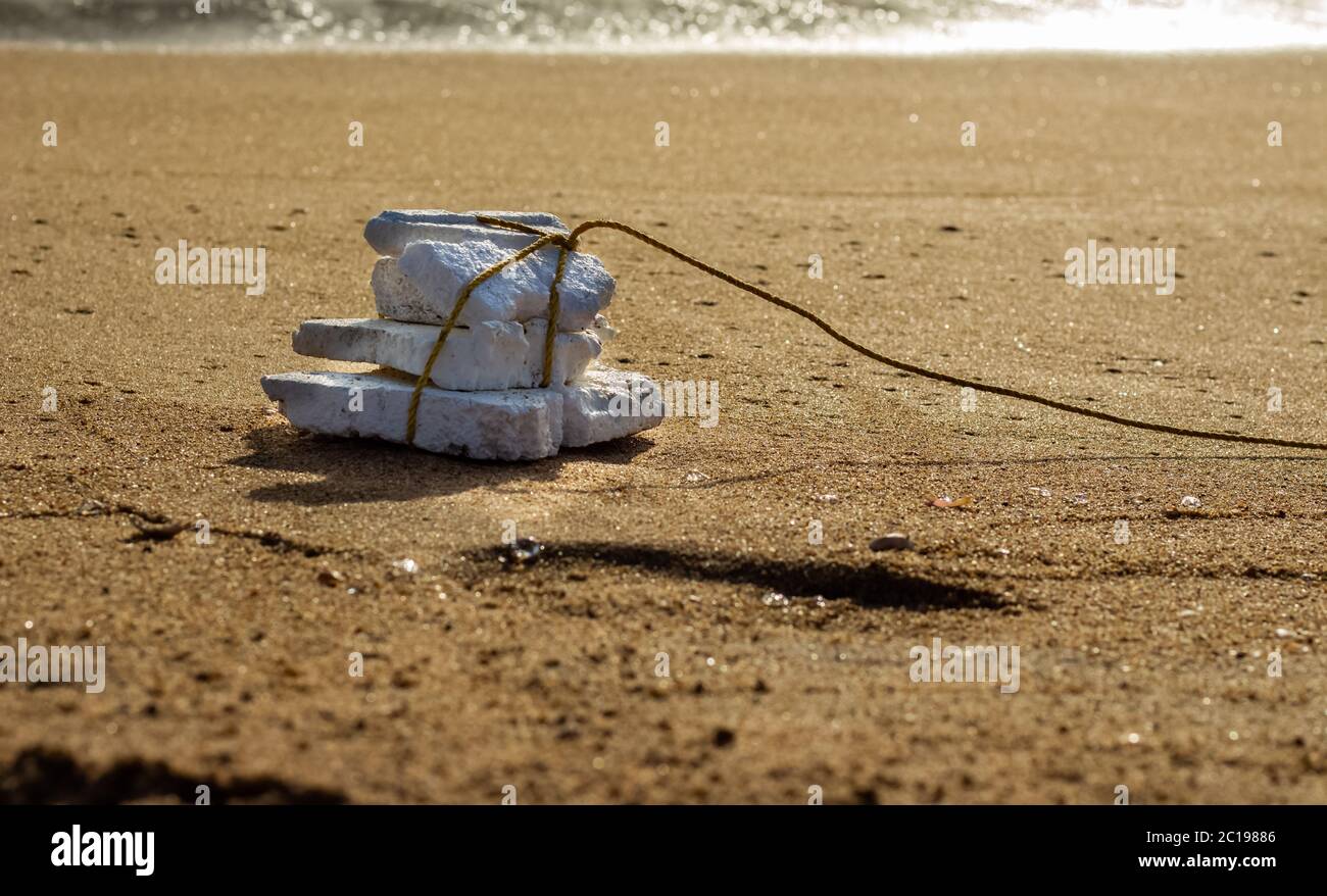 Thermocol Fishnet Float on beach sand with background sea waves Stock ...