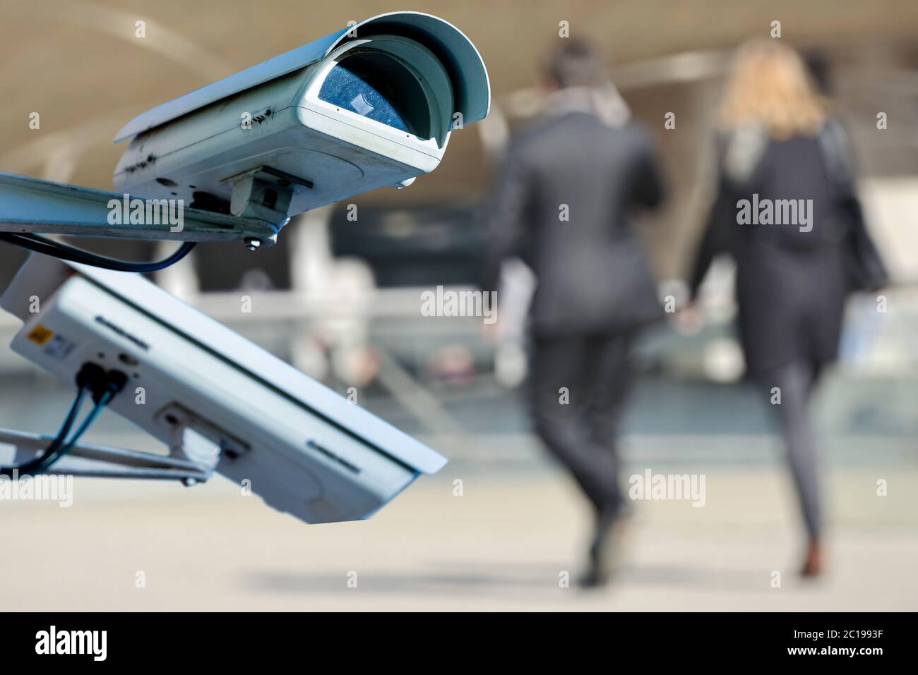 security CCTV camera or surveillance system with women on blurry ...