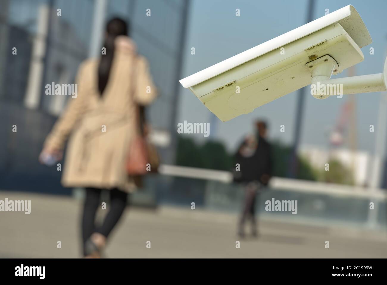 security CCTV camera or surveillance system with woman on blurry ...